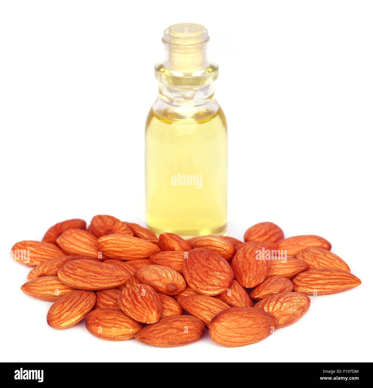 Fresh almonds with oil over white background Stock Photo - Alamy