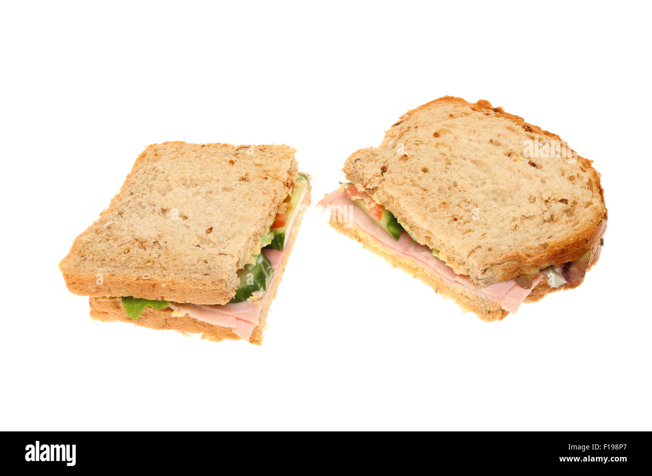 Two halves of a ham sandwich made with multi grain bread isolated ...