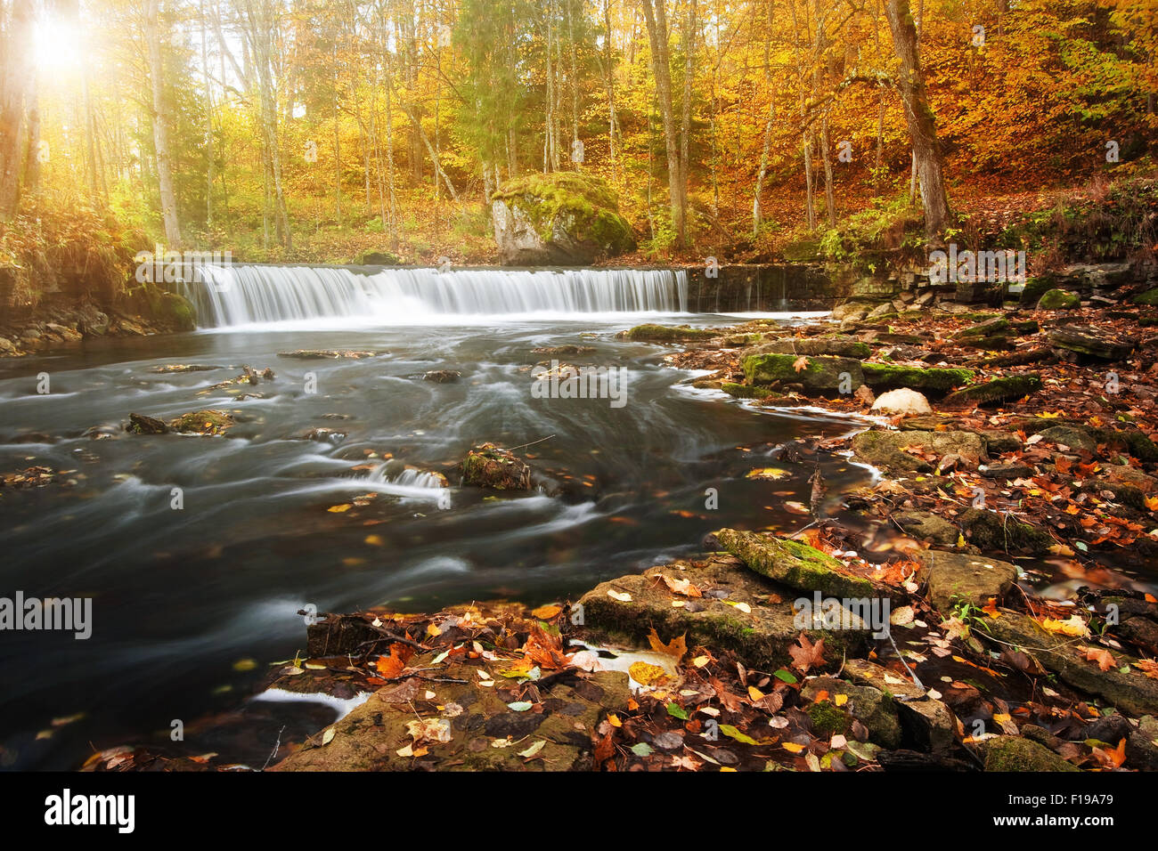 waterfall with a shining sun Stock Photo - Alamy