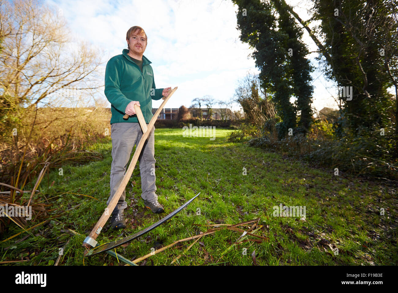 A conservation worker uses a scythe at the Rivermead Nature Park in ...