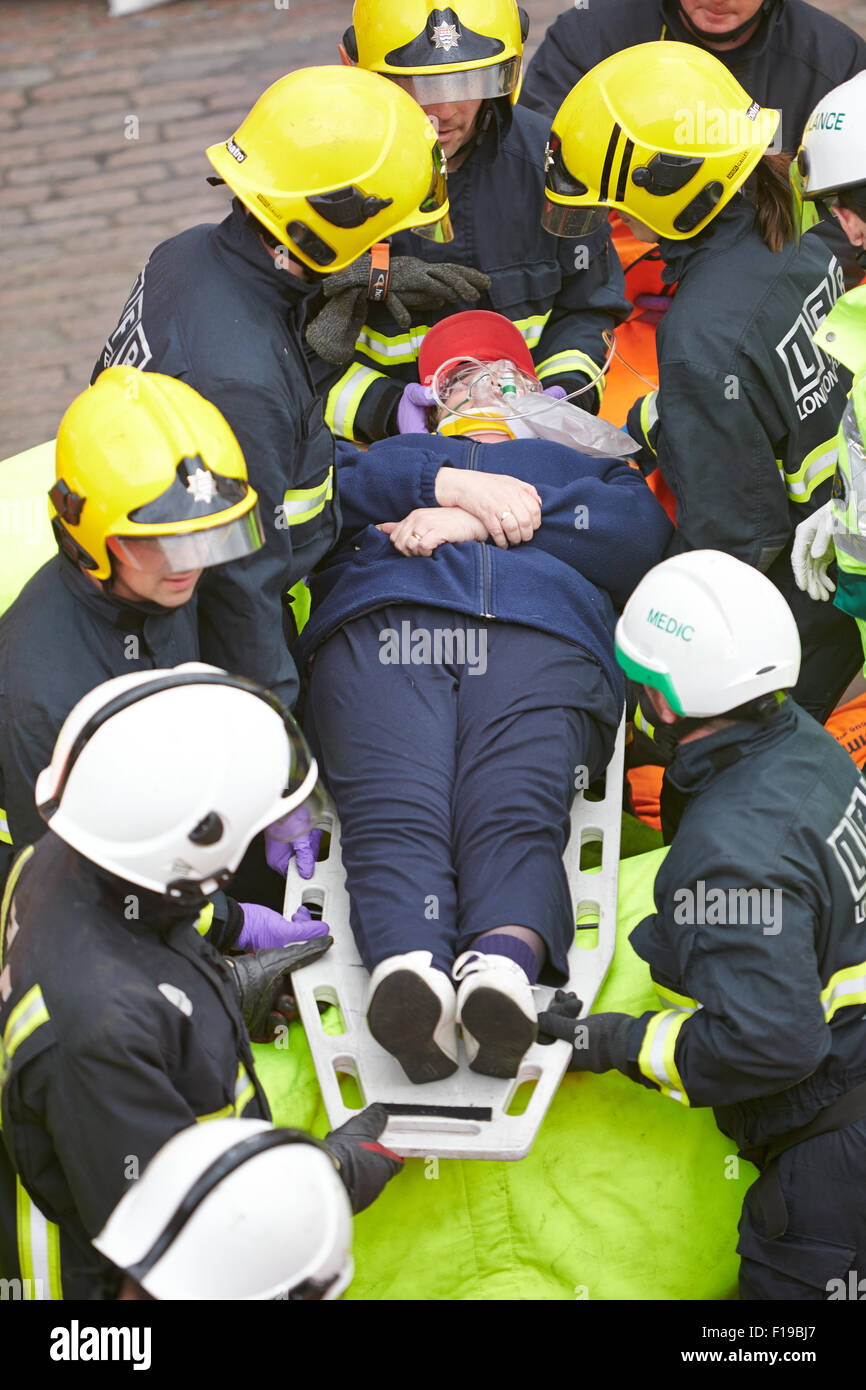 The London Fire Brigade extraction team demonstrate rescuing simulated ...