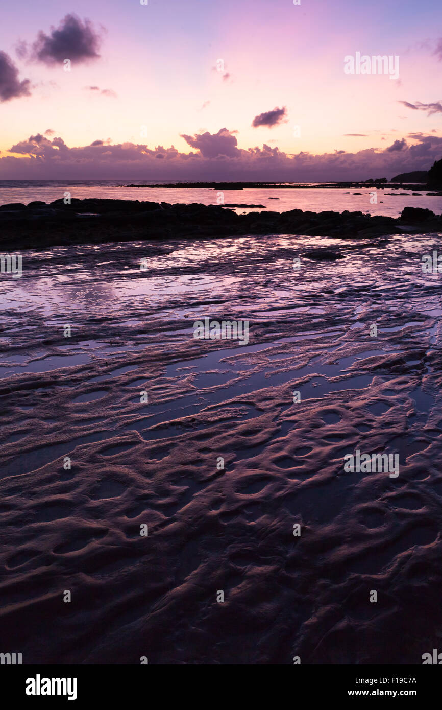 Beautiful rock patterns and sunrise at shore Stock Photo - Alamy
