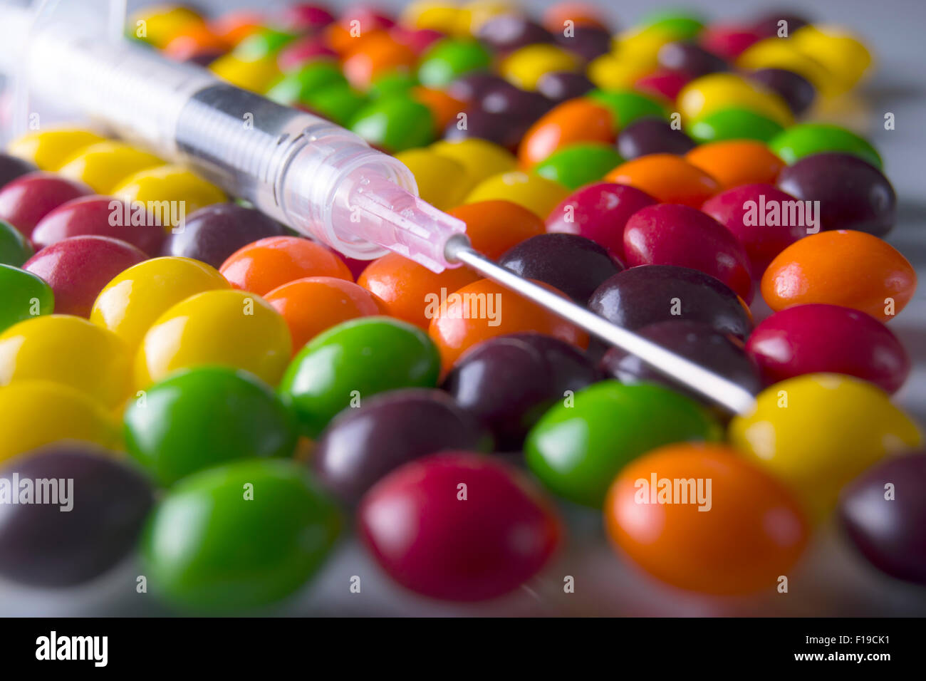 Syringe with candy, diabetes Stock Photo - Alamy