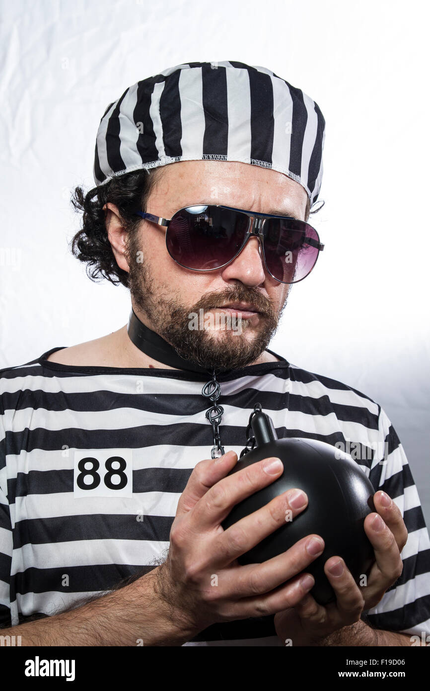 Desperate, portrait of a man prisoner in prison garb, over white ...