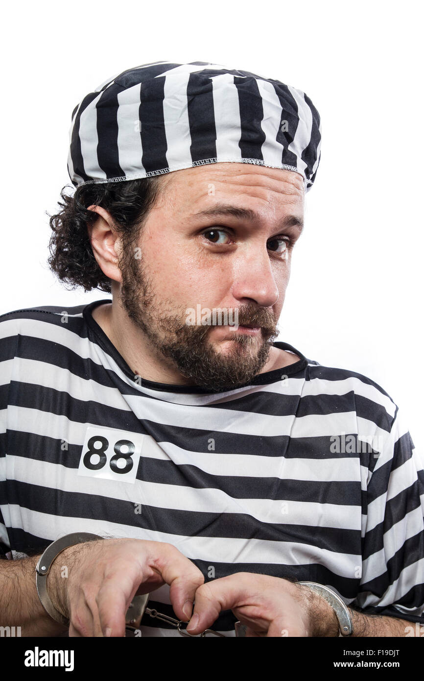 Desperate, portrait of a man prisoner in prison garb, over white ...