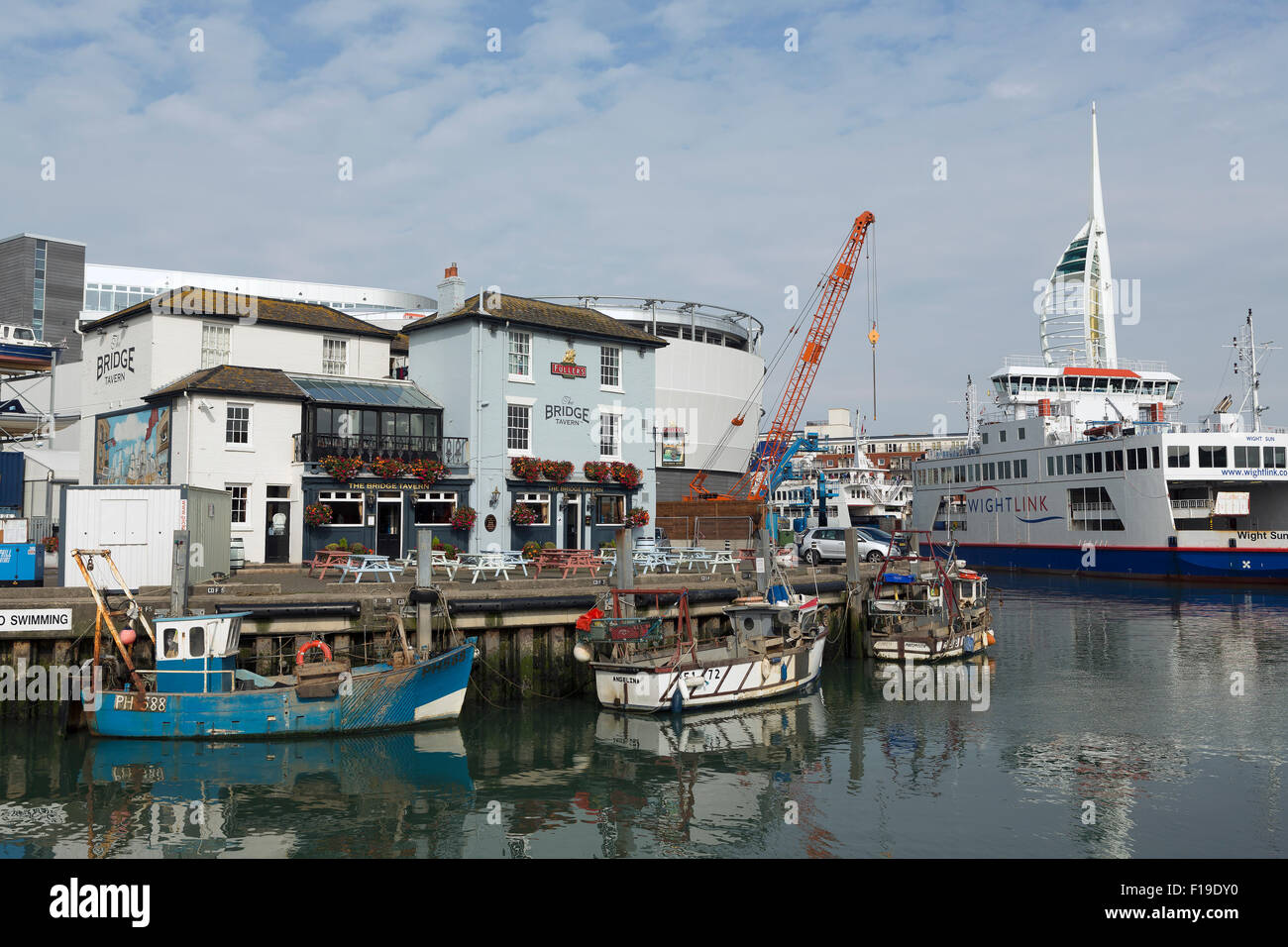 Fishing boats and car ferry moored in the Camber Docks in old ...