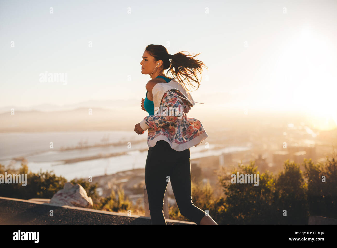 Outdoor shot of a young woman on her morning run. Fitness woman running ...