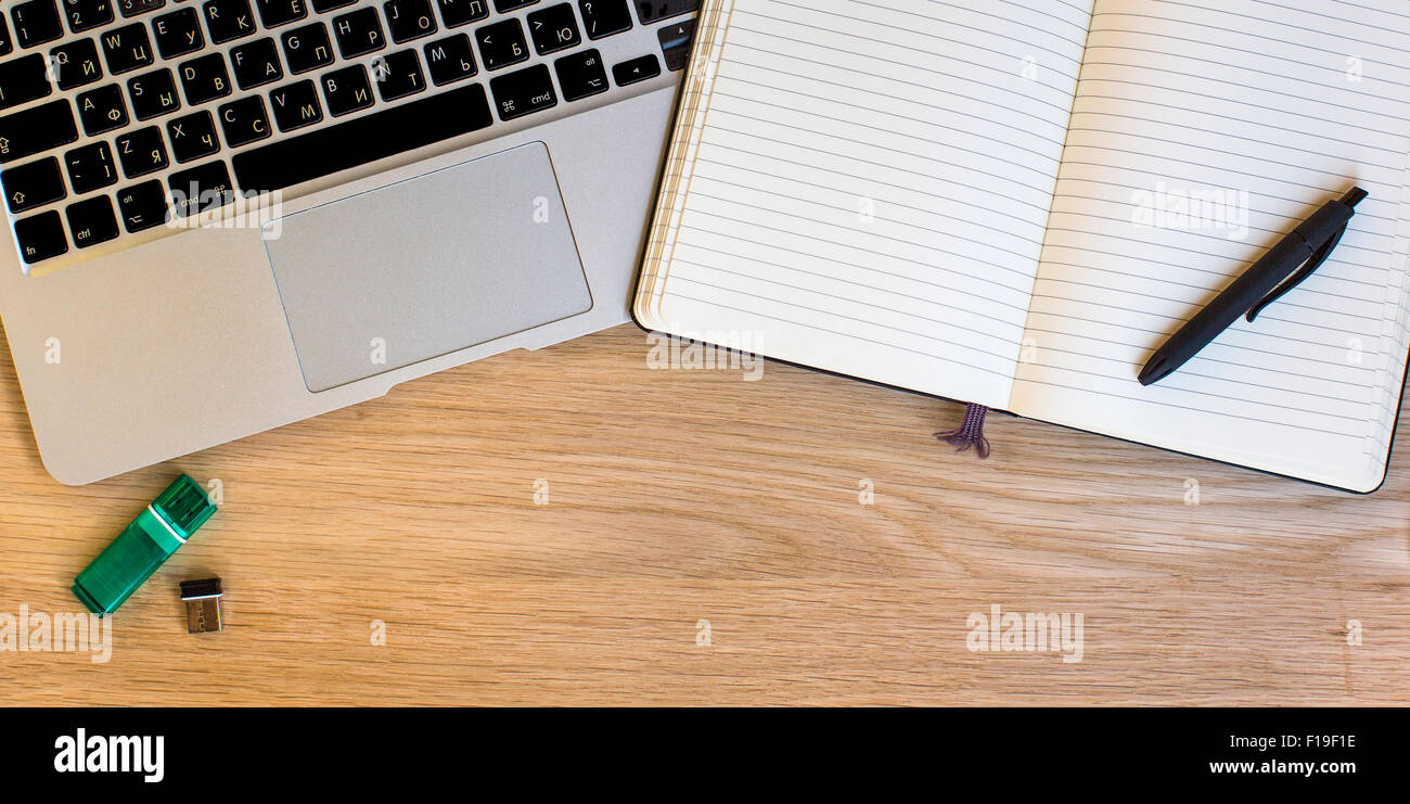 Laptop and Notepad with pen top view on the background of wood texture ...