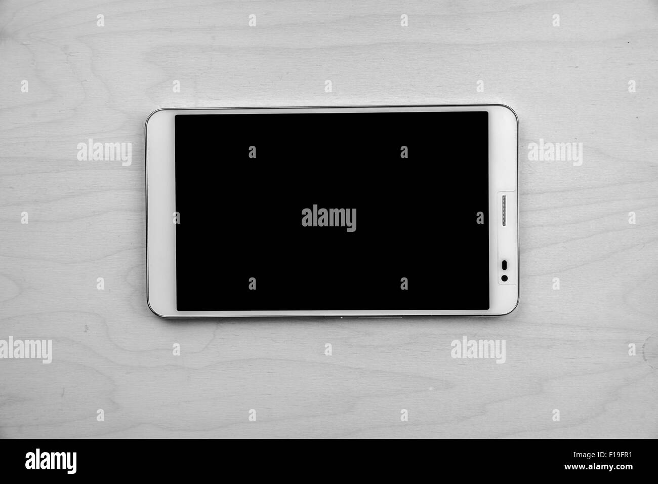 Tablet phone on wooden Black and White Stock Photos & Images - Alamy