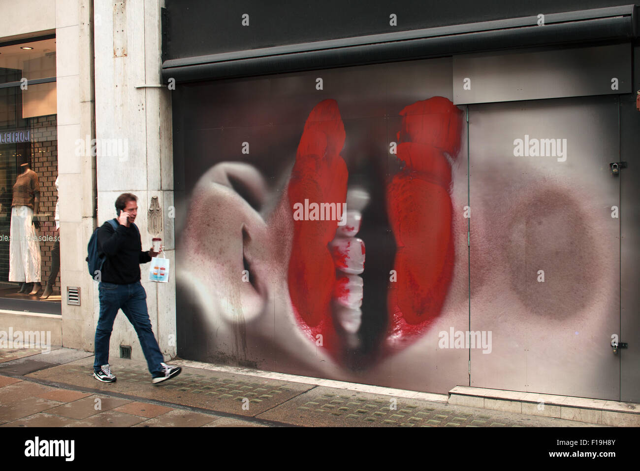 London UK man passing by store front Stock Photo - Alamy