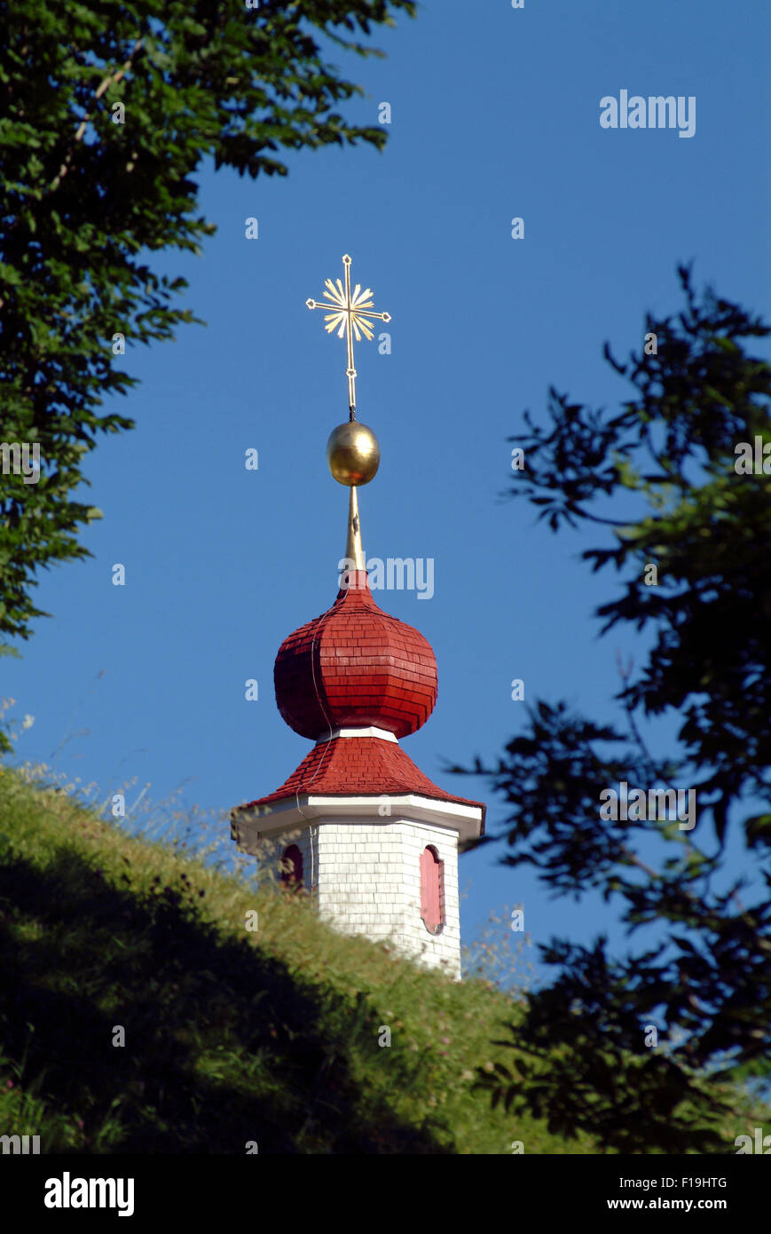 Church tower and tree in alps austria europe Stock Photo - Alamy