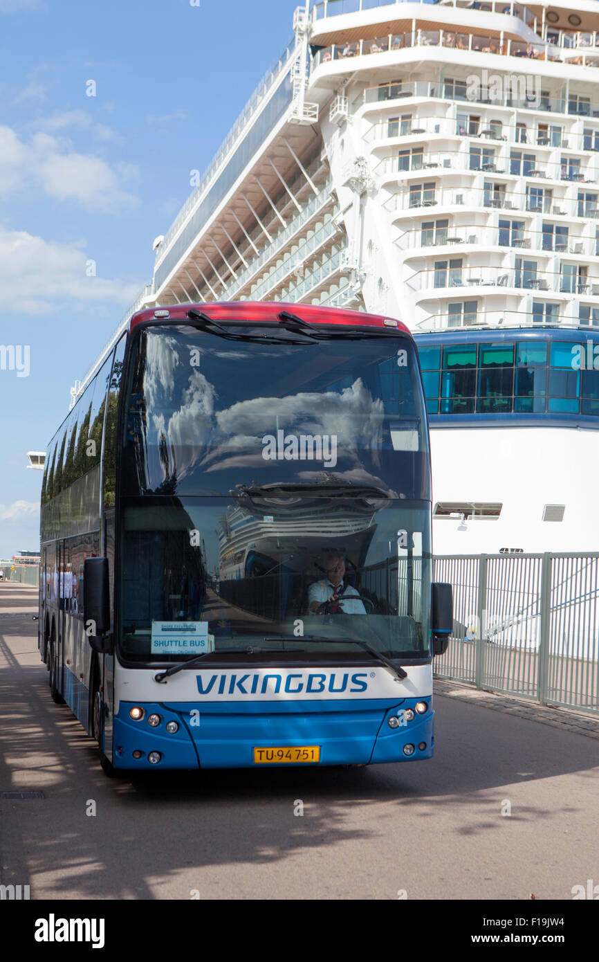 Passenger shuttle bus for cruise line passengers next to a cruise ship ...