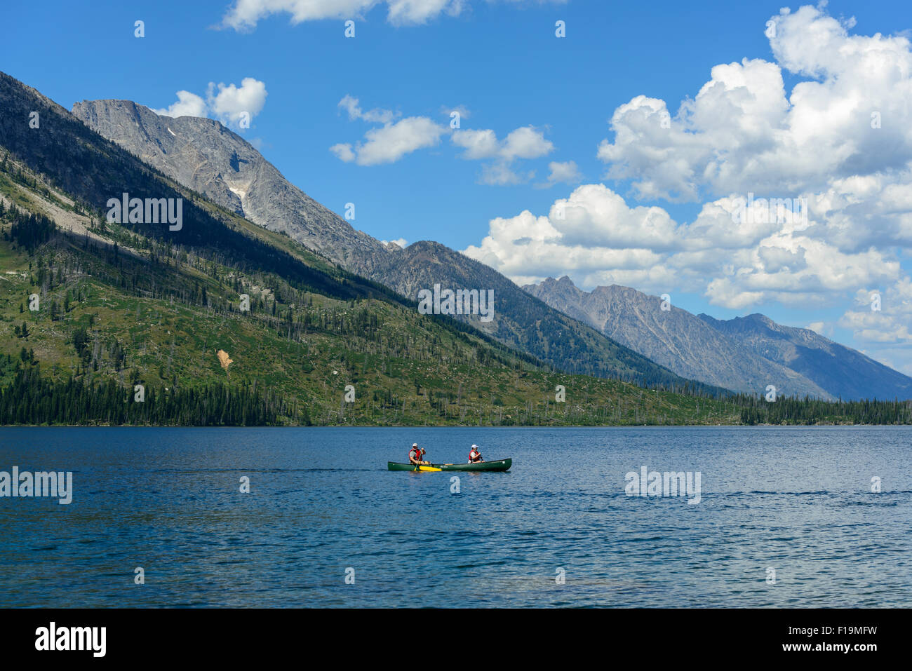 Two people rowing in a kayak during a sunny summer afternoon in Jenny ...