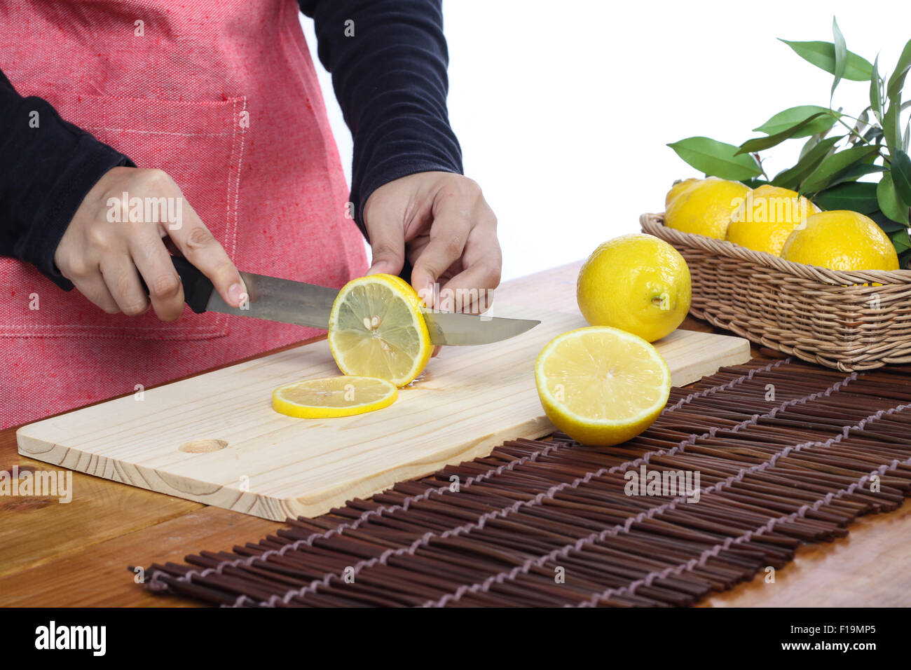 woman cutting lemon in clean environment Stock Photo - Alamy