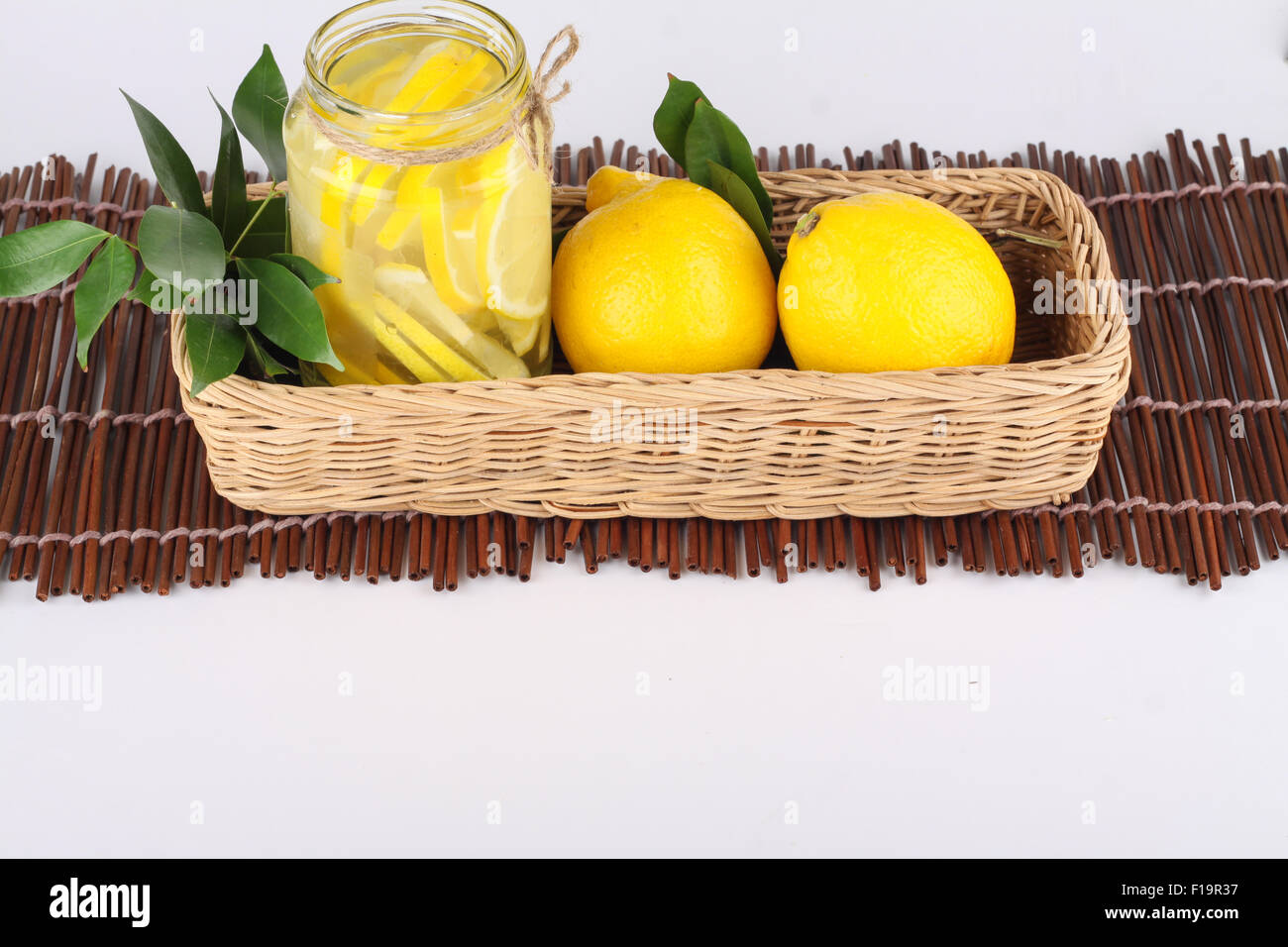 lemonade with some uncut lemon inside a basket ready copy space Stock ...