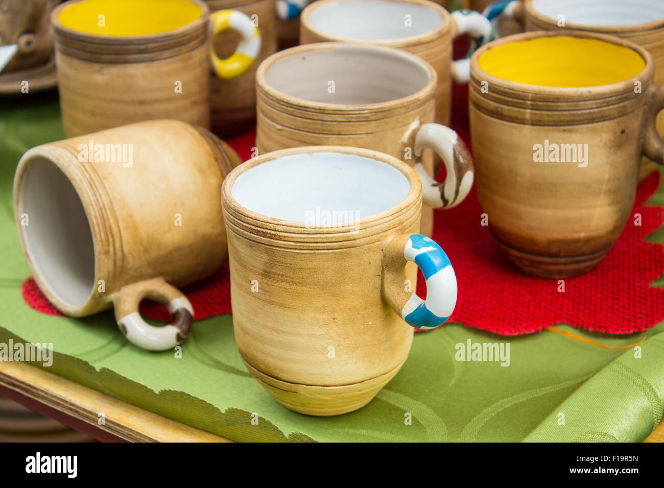 Collection of colorful cups for sale on stall at the bazaar, kitchen ...
