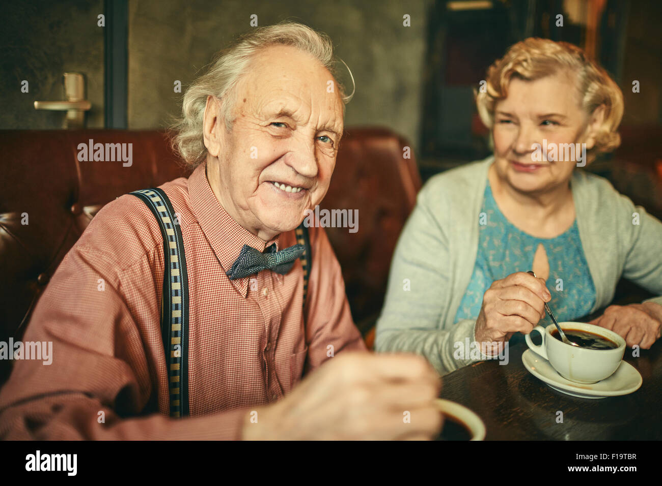 Happy seniors sitting in cafe Stock Photo - Alamy