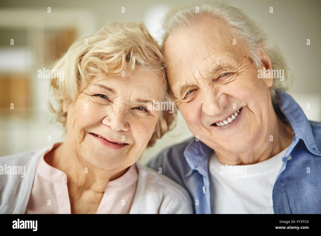 Smiley faces of affectionate senior couple Stock Photo - Alamy
