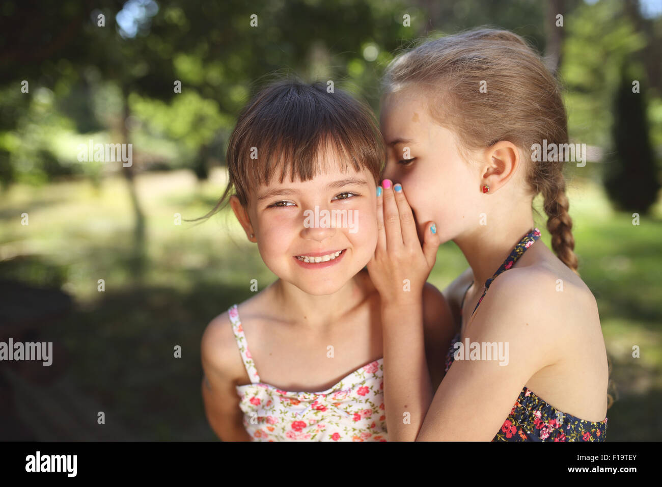 Sisters whispering secrets hi-res stock photography and images - Alamy