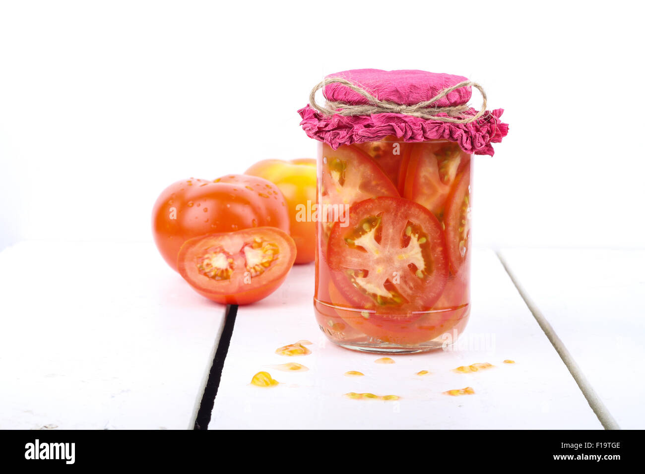 tomatoes in a jar with white background Stock Photo - Alamy