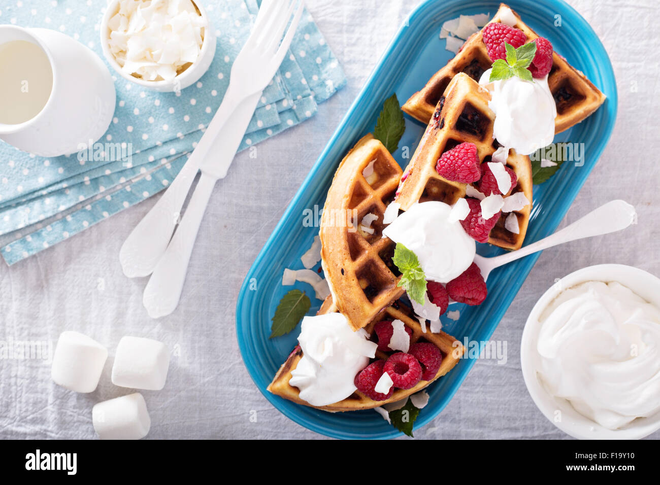 Coconut raspberry waffles served with fresh berries and whipped cream ...