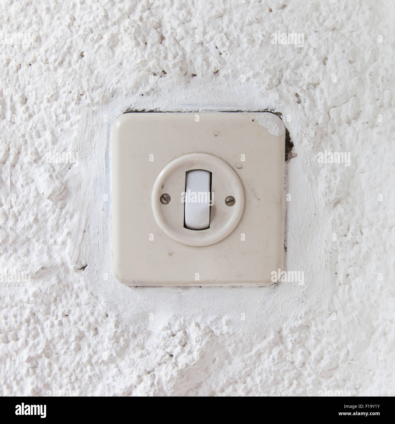Press turn on/off electrical switch, old plaster wall Stock Photo - Alamy