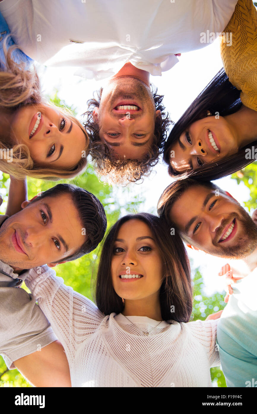 Group of happy friends hugging together at the park in a circle Stock ...