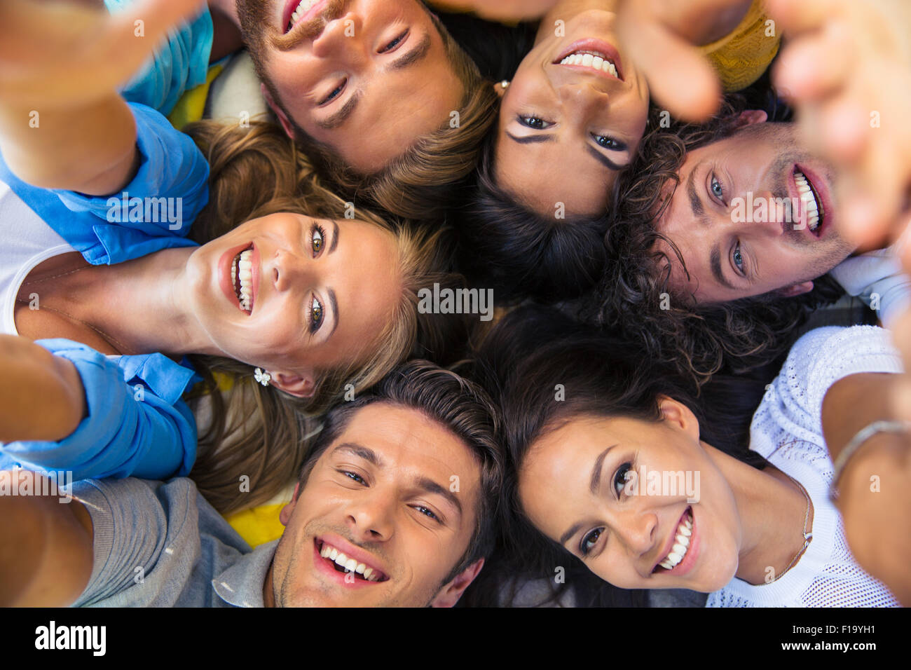 Group of happy friends lying together in a circle Stock Photo - Alamy
