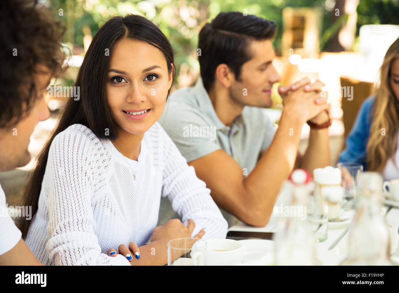 Happy friends enjoying meal in outdoor restaurant Stock Photo - Alamy
