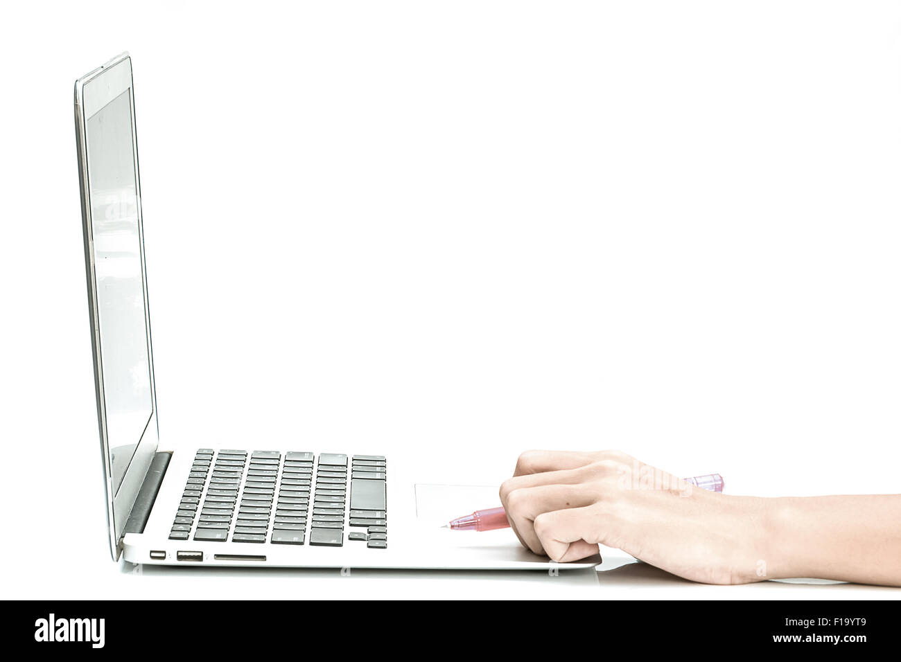 Hands with pen on laptop Stock Photo - Alamy