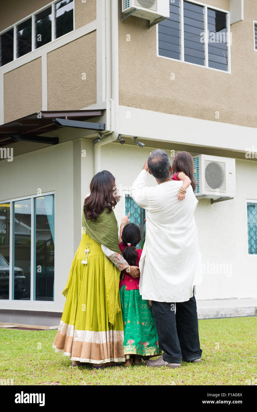 Rear view of Indian family in traditional dress saree standing outdoors ...