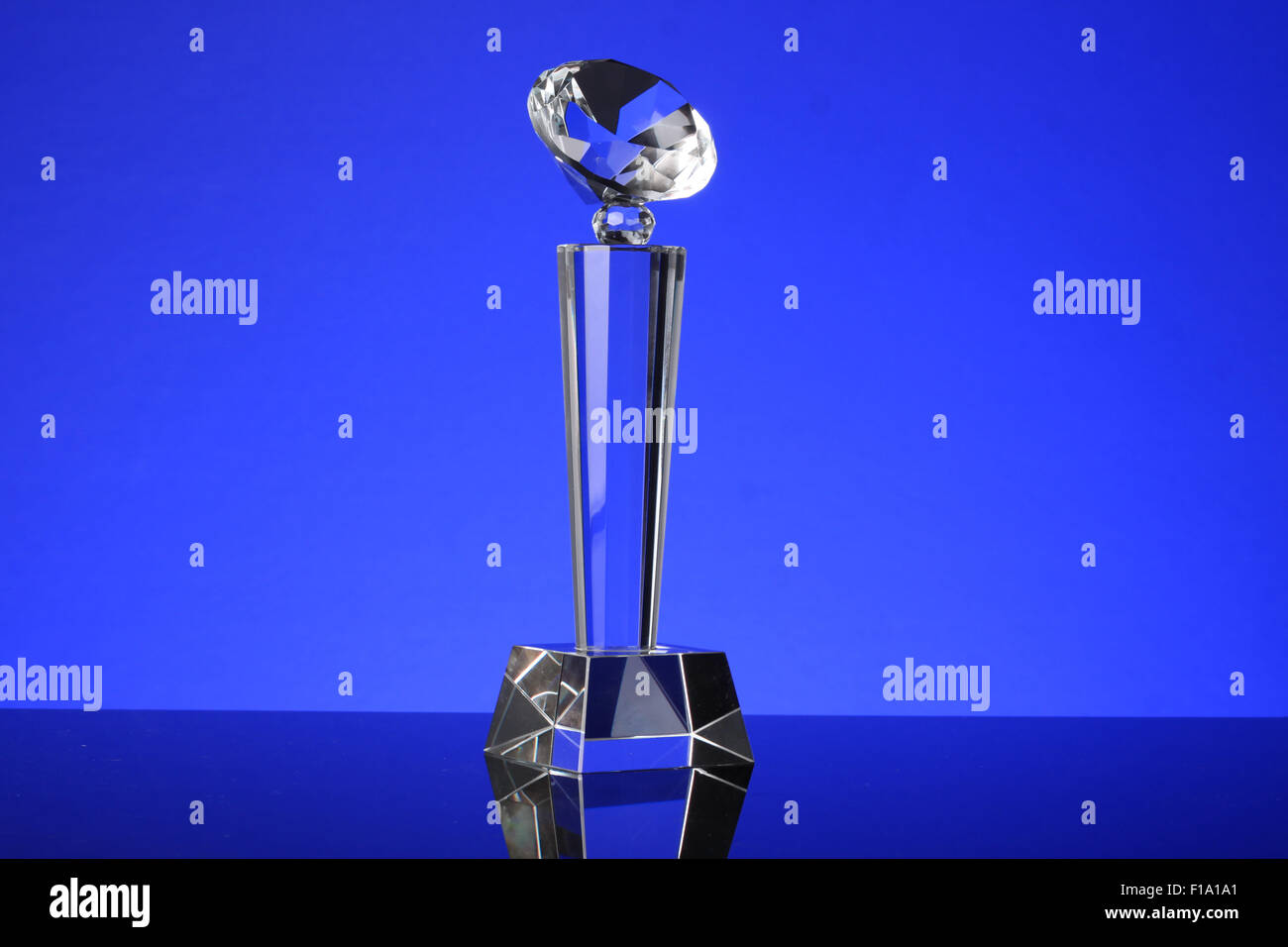 glass trophy in blue background Stock Photo - Alamy