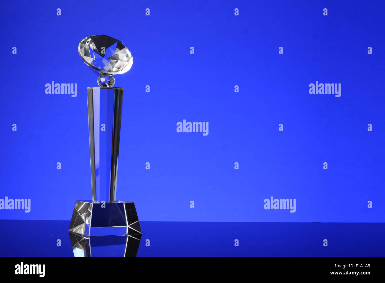 glass trophy in blue background Stock Photo - Alamy