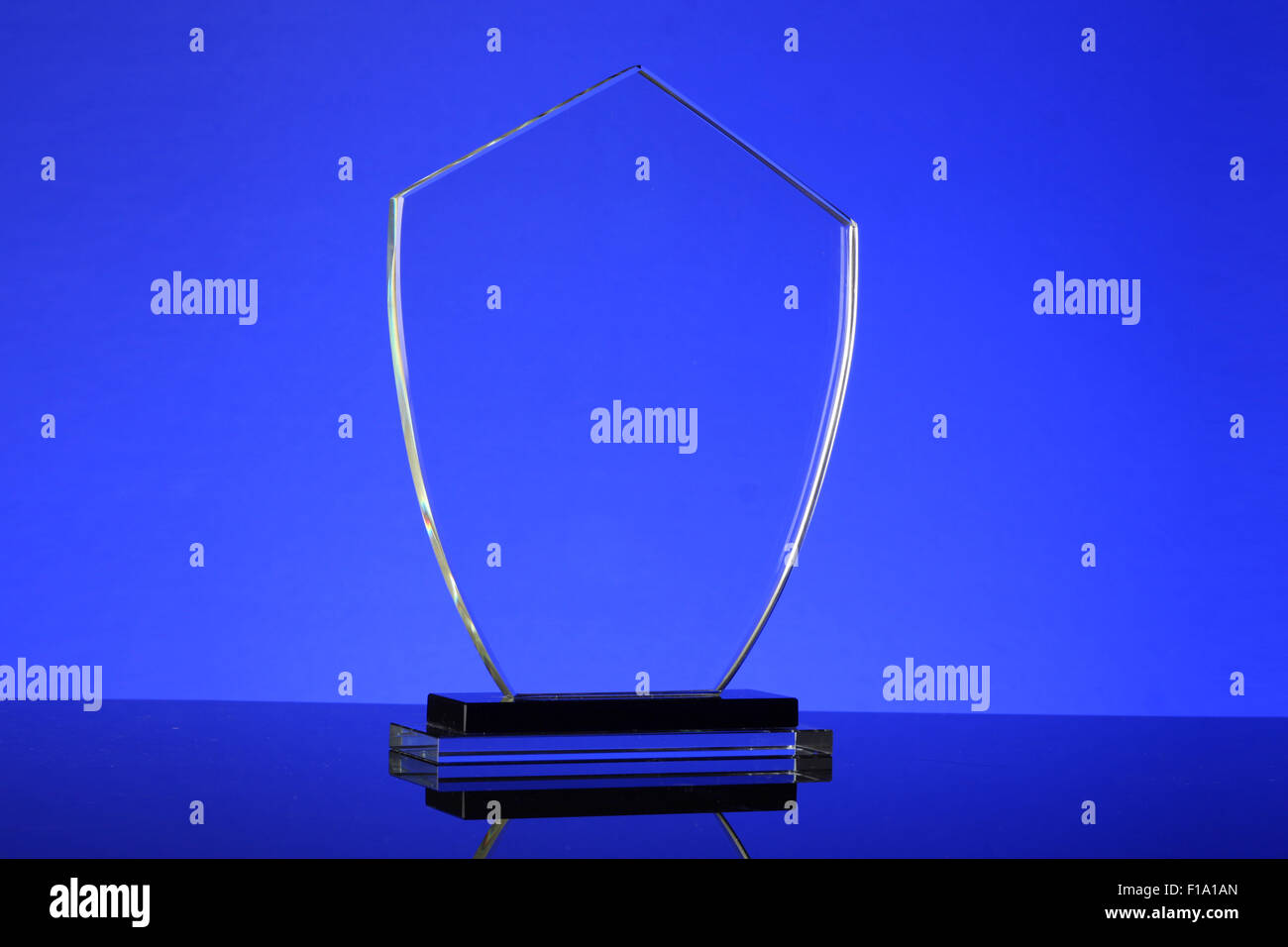 glass trophy in blue background Stock Photo - Alamy