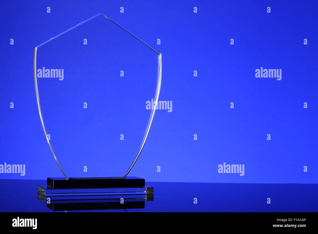 glass trophy in blue background Stock Photo - Alamy