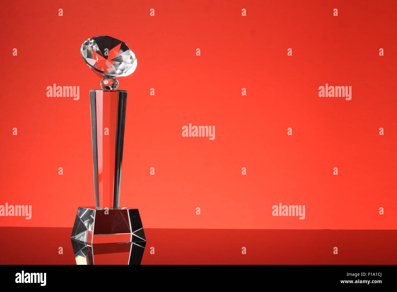 glass trophy in red background Stock Photo - Alamy