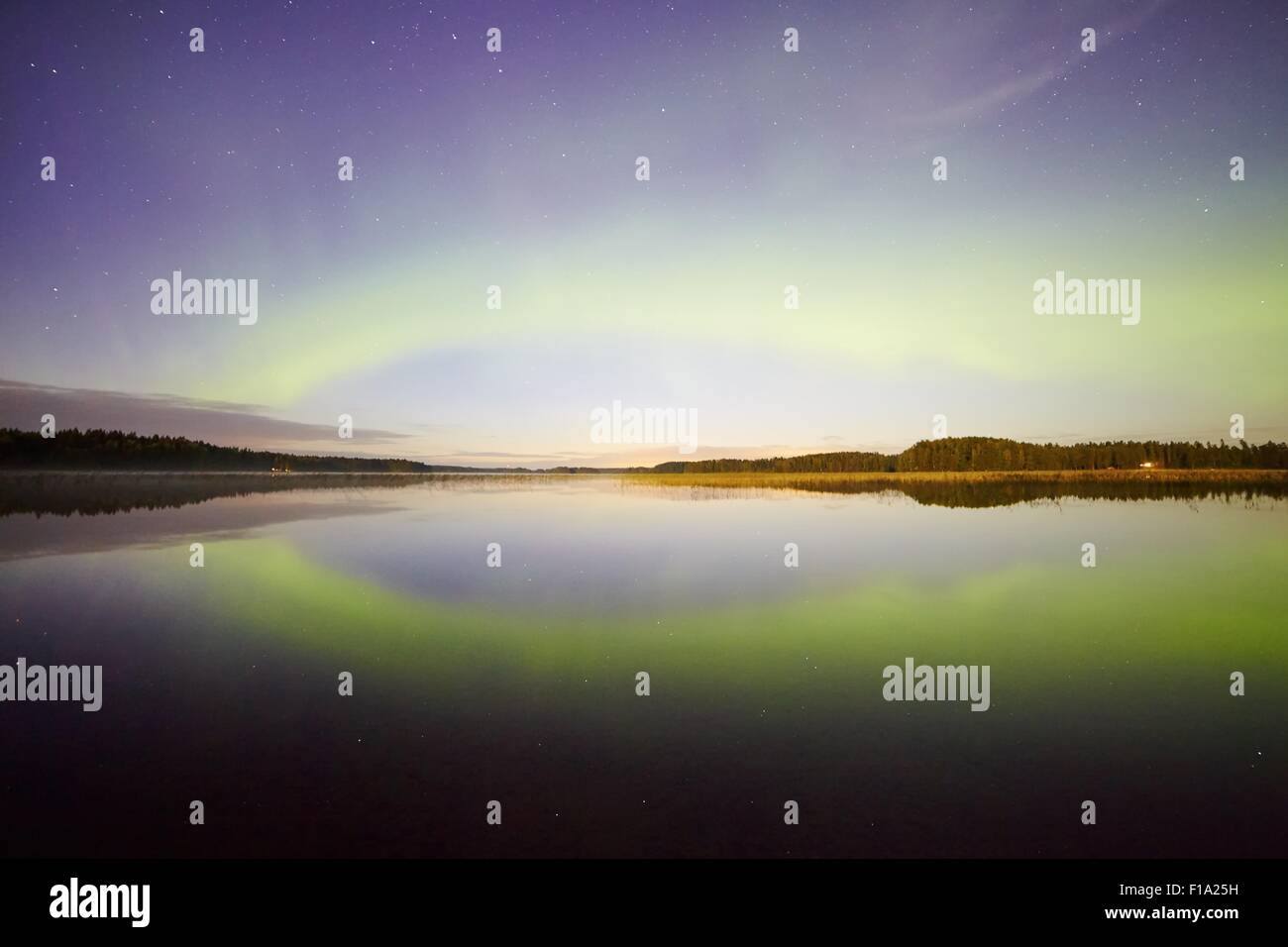 Northern lights with reflection on the lake at night Stock Photo - Alamy