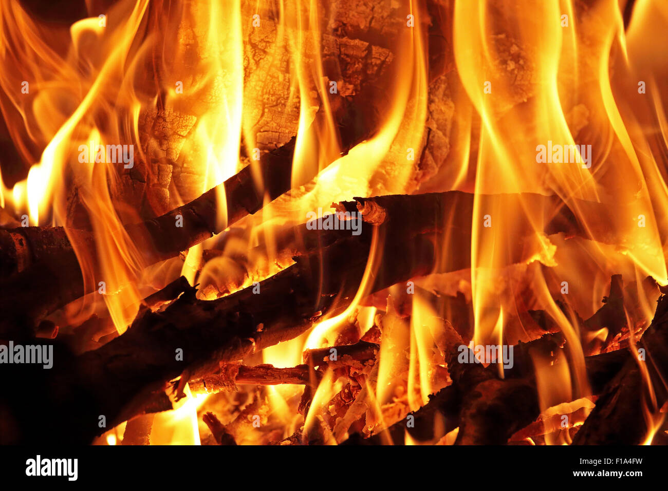 Closeup flames of a wood fire with burning logs and branches Stock ...