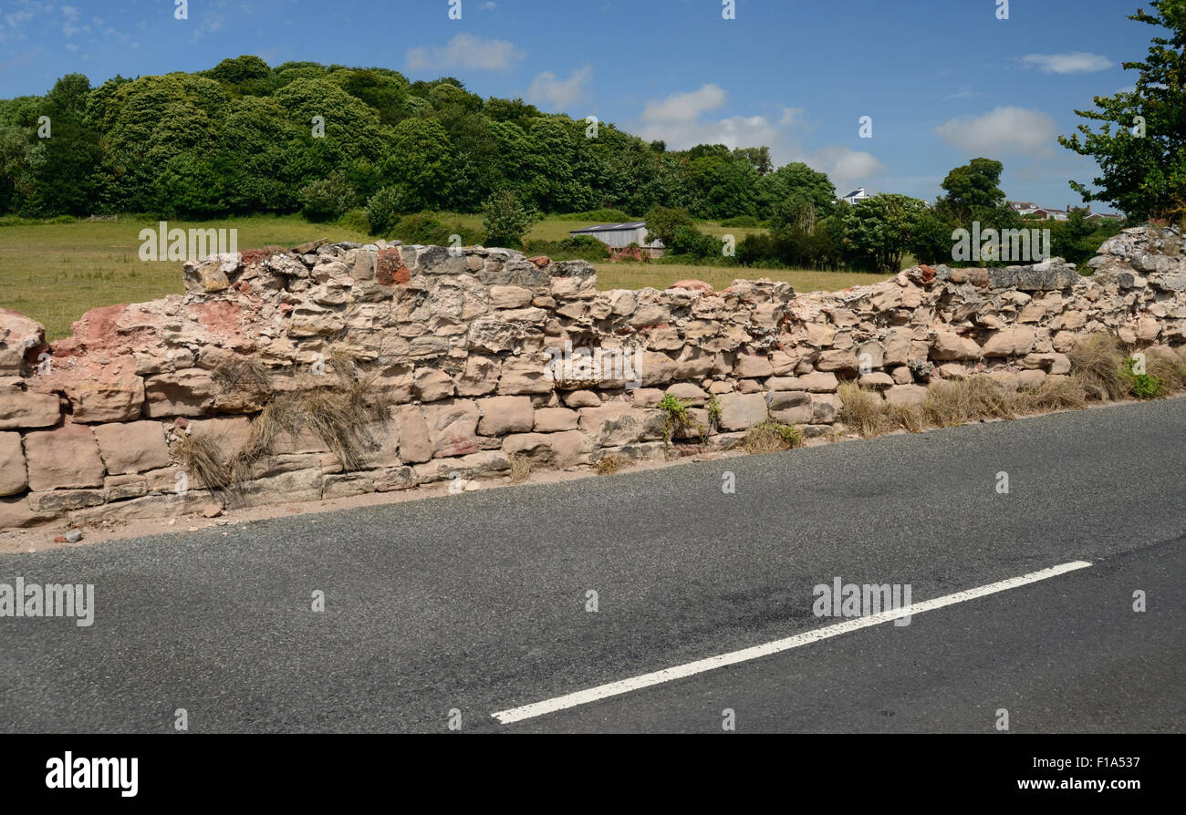 A roadside wall in need of some repair Stock Photo - Alamy
