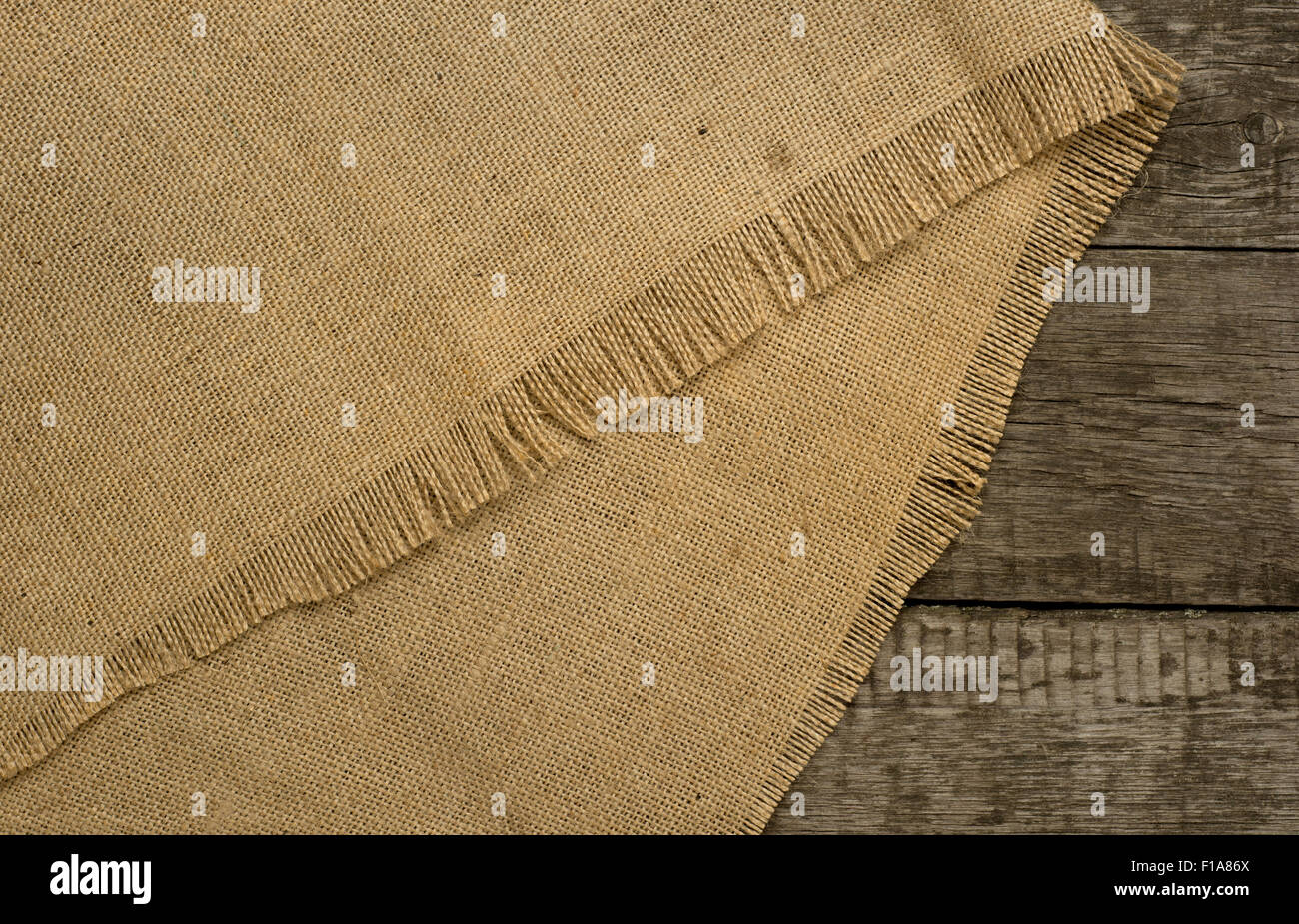 Burlap on rustic wooden background. Top view Stock Photo - Alamy