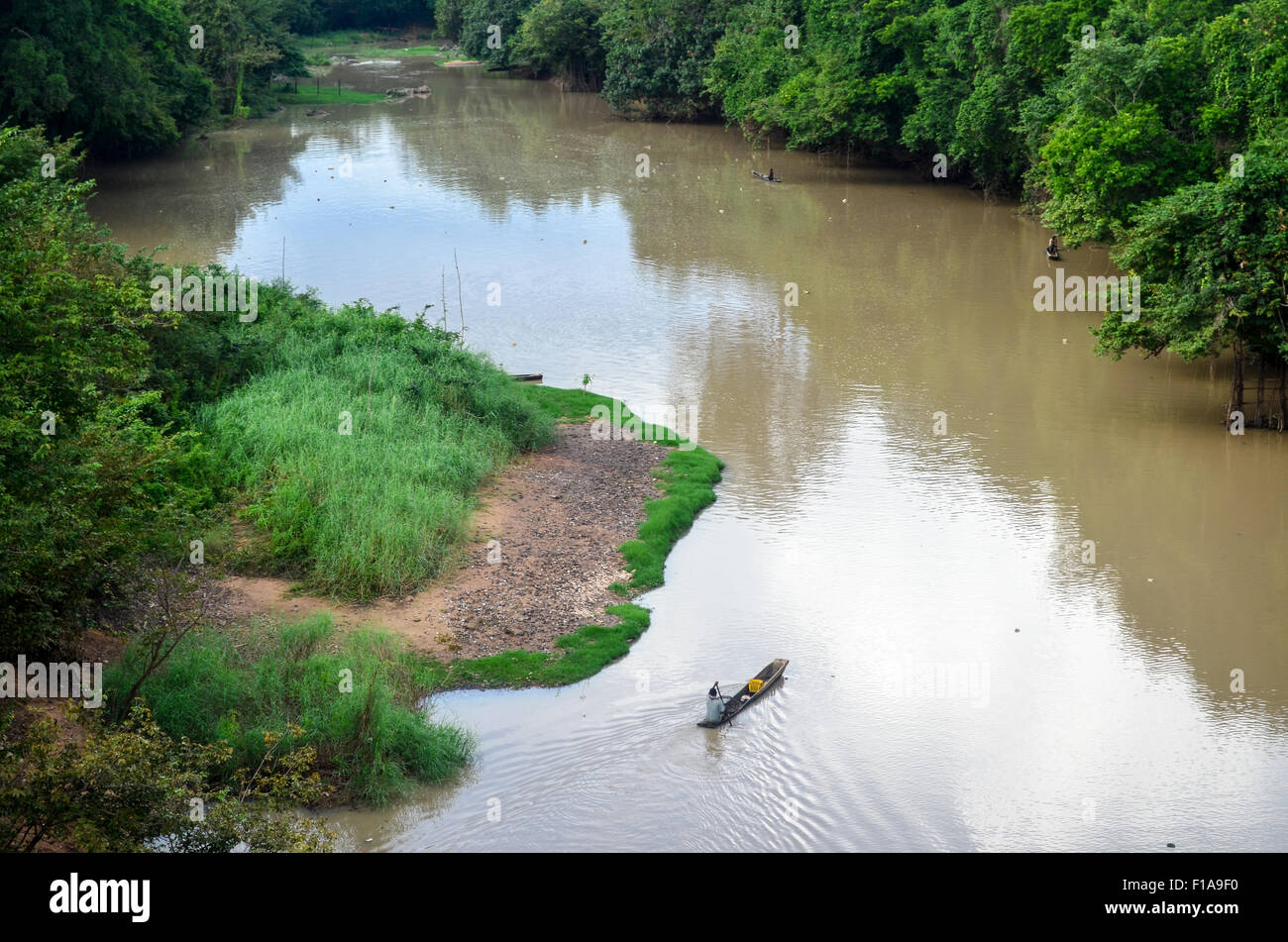 Man in a pirogue navigating on a river in Ivory Coast Stock Photo - Alamy