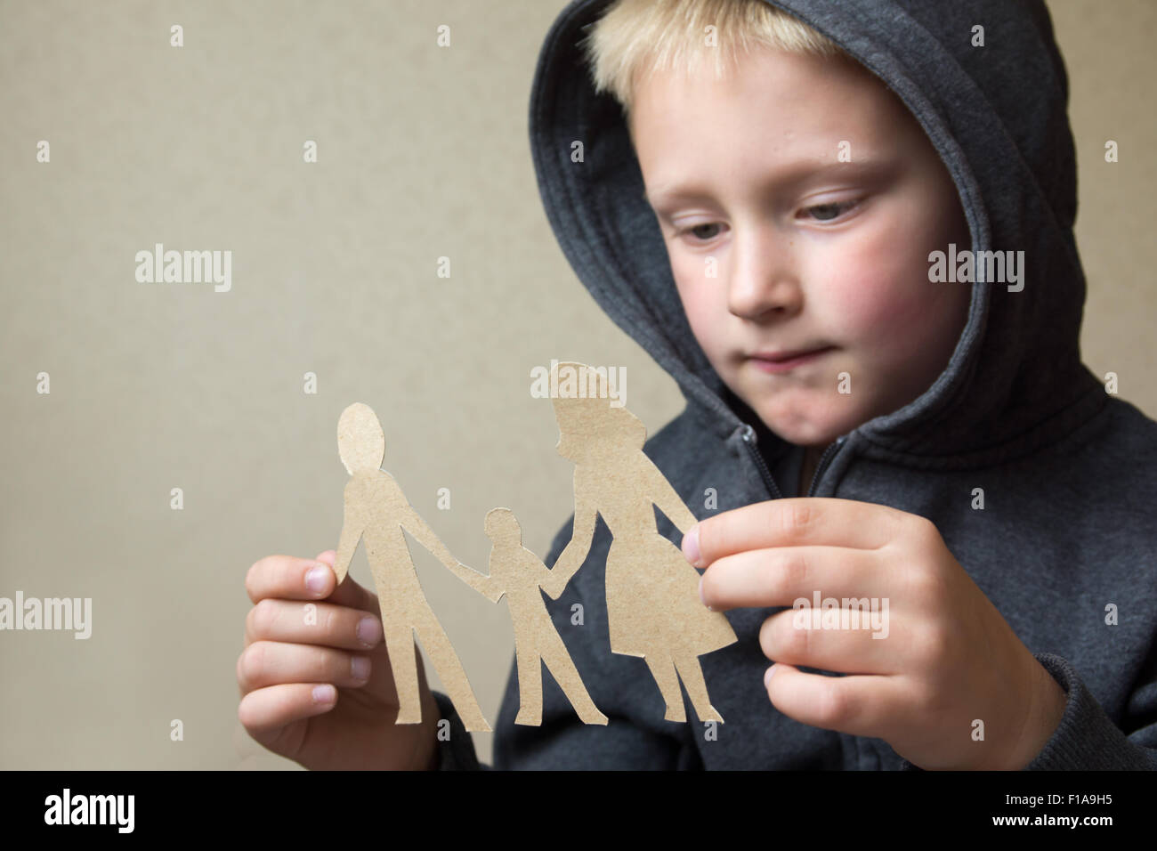 Confused child with paper family, family problems, divorce, suffer ...