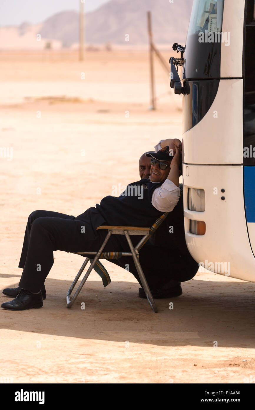 Coach drivers at Wadi Rum, sheltering from desert sun. Jordan. Middle ...