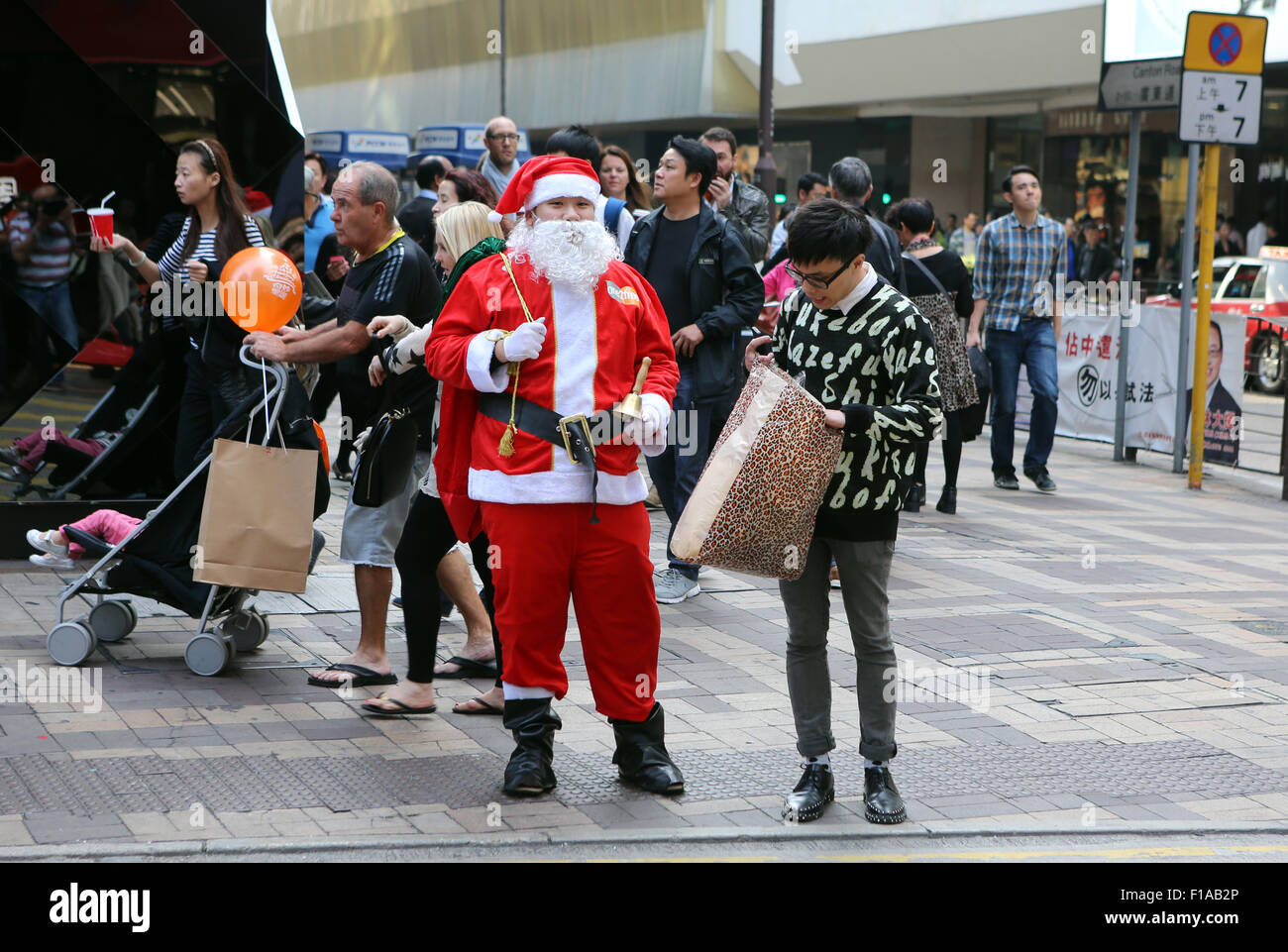 Hong Kong, China, Santa Claus on a busy street Stock Photo - Alamy