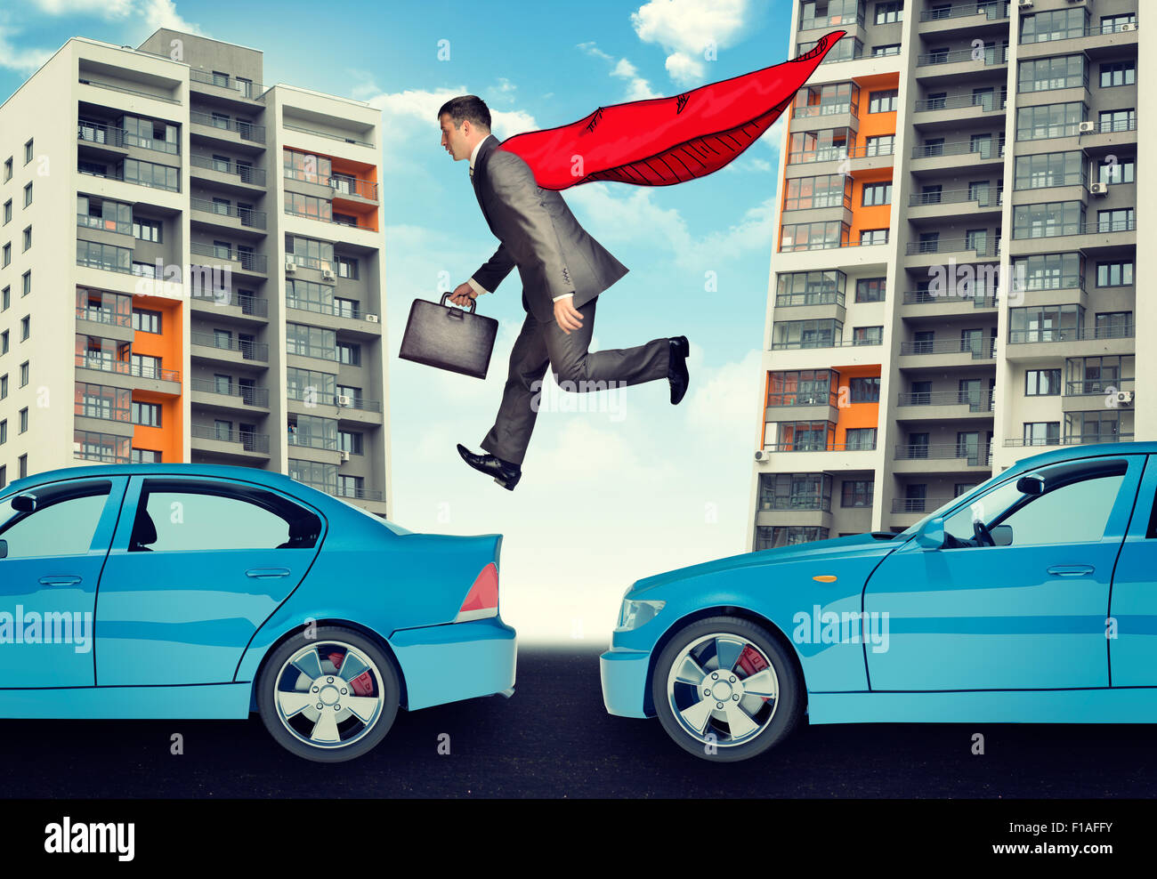Businessman springing over cars Stock Photo - Alamy