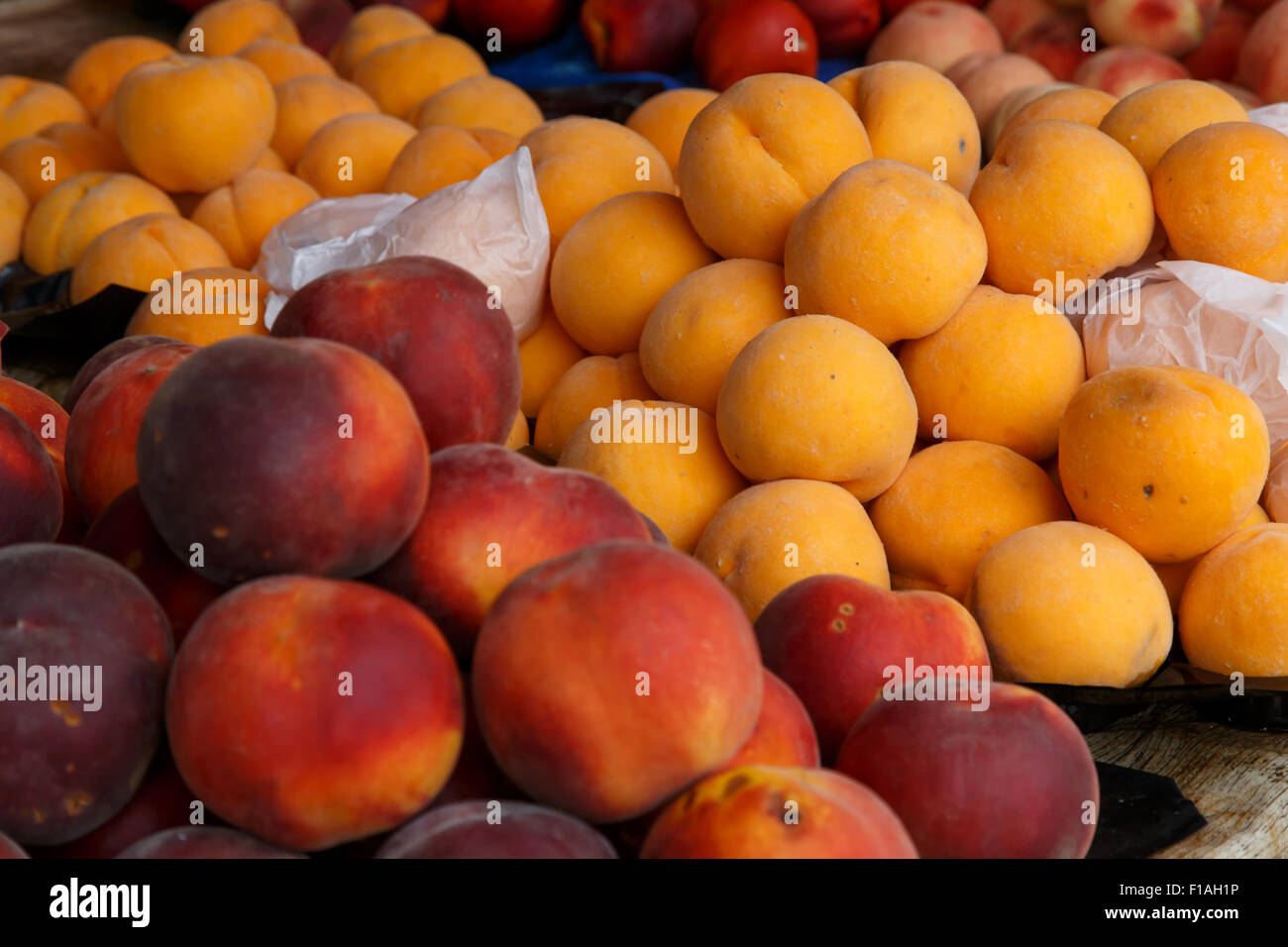 two different peaches types on marketplace Stock Photo - Alamy