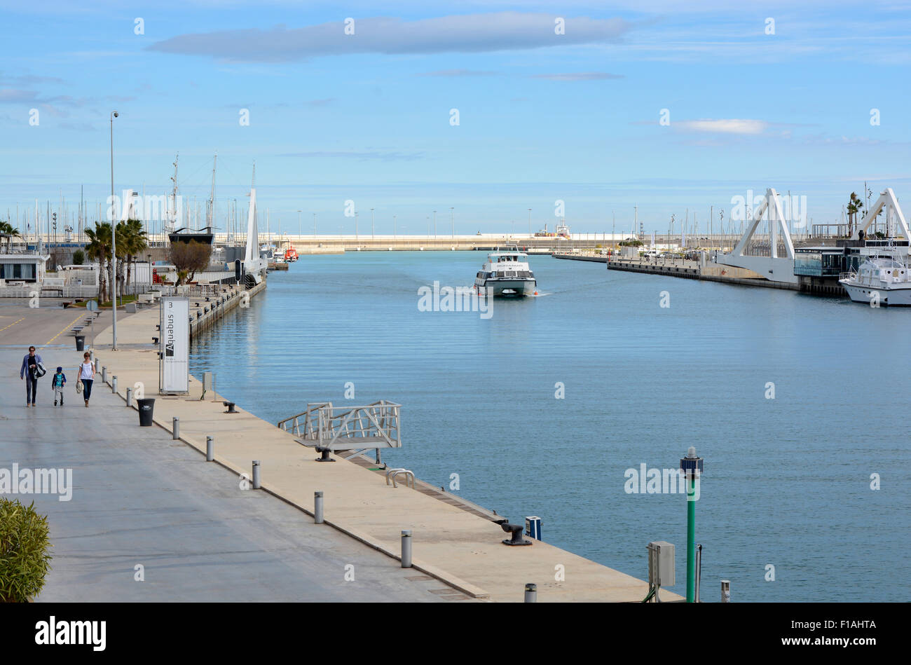 Boat entering harbour area of the Port at Valencia. Spain. With people ...