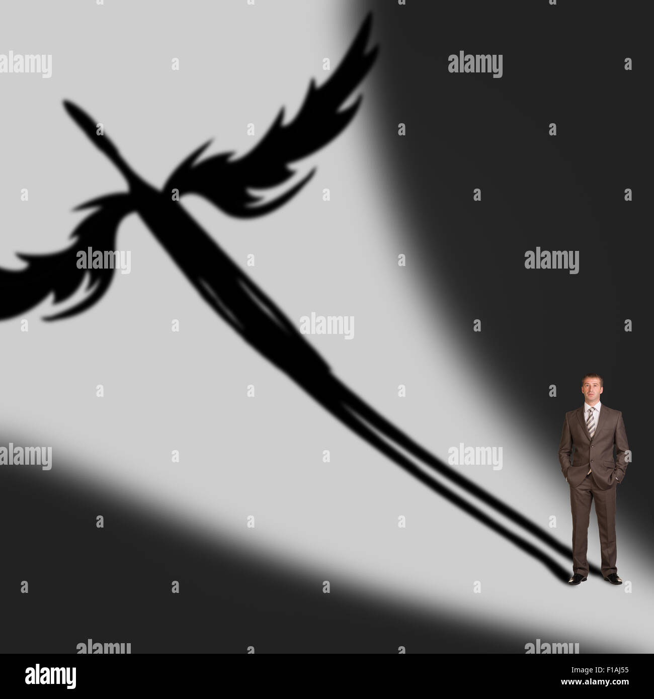 Businessman with angel shadow Stock Photo - Alamy