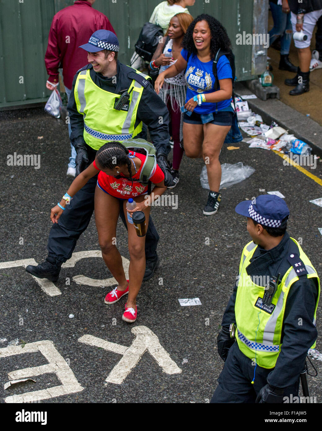 London, UK. 31 August, 2015. A woman whining a police officer during ...