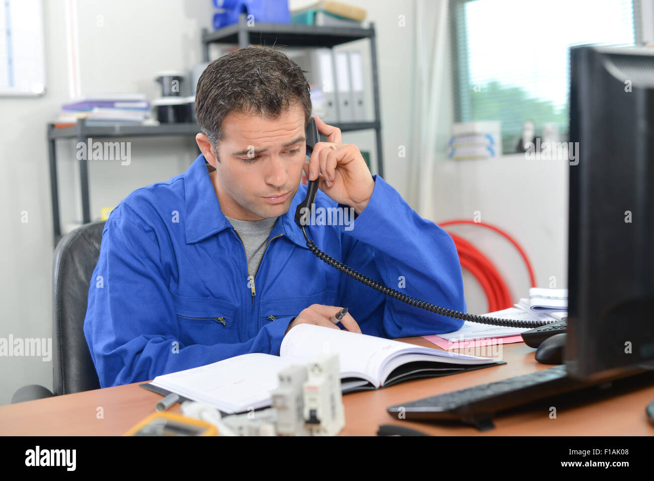 Electrician working at his desk Stock Photo - Alamy